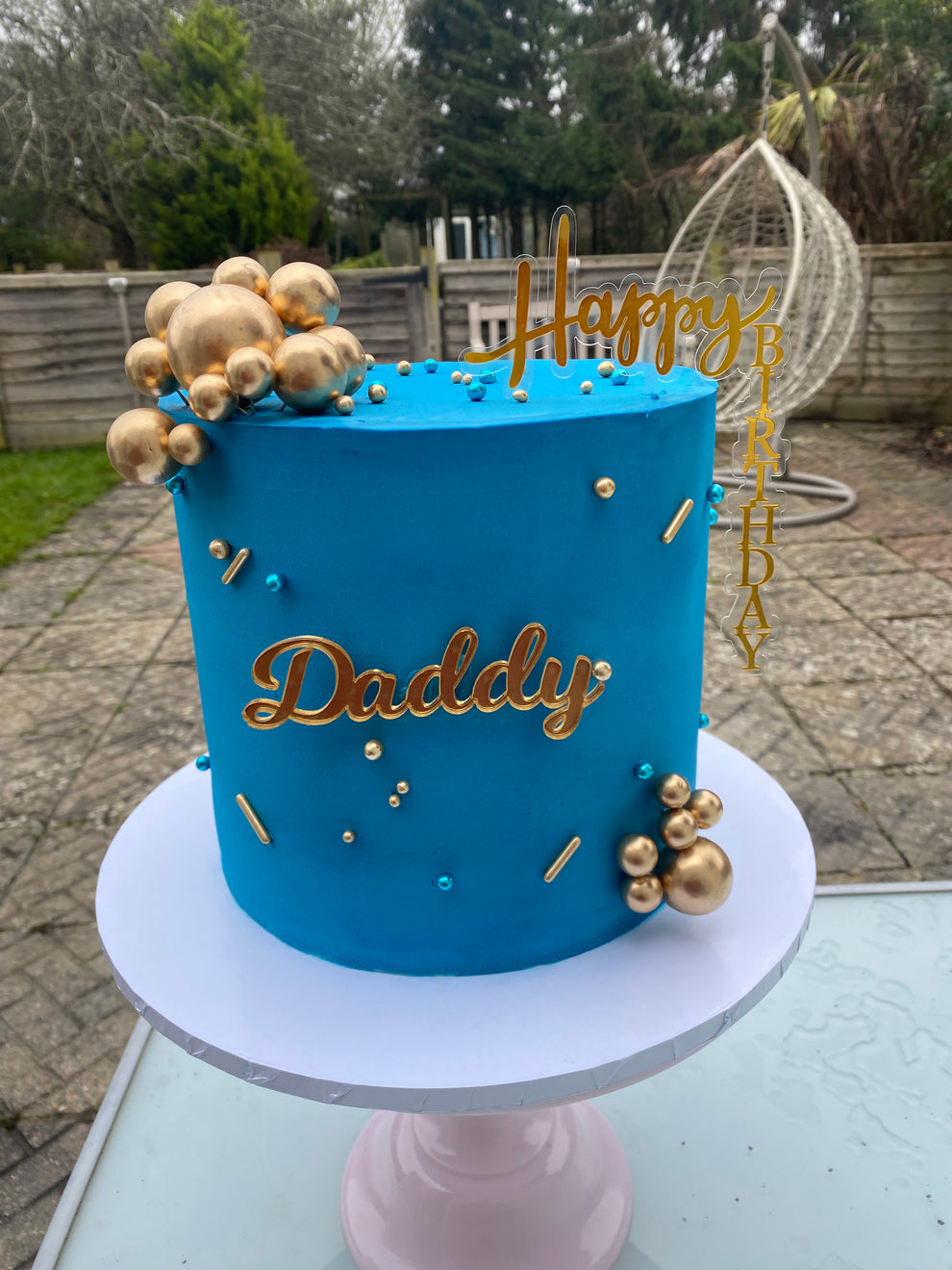 Deep blue cake with gold ball decorations – Thistleberry Cake Studio